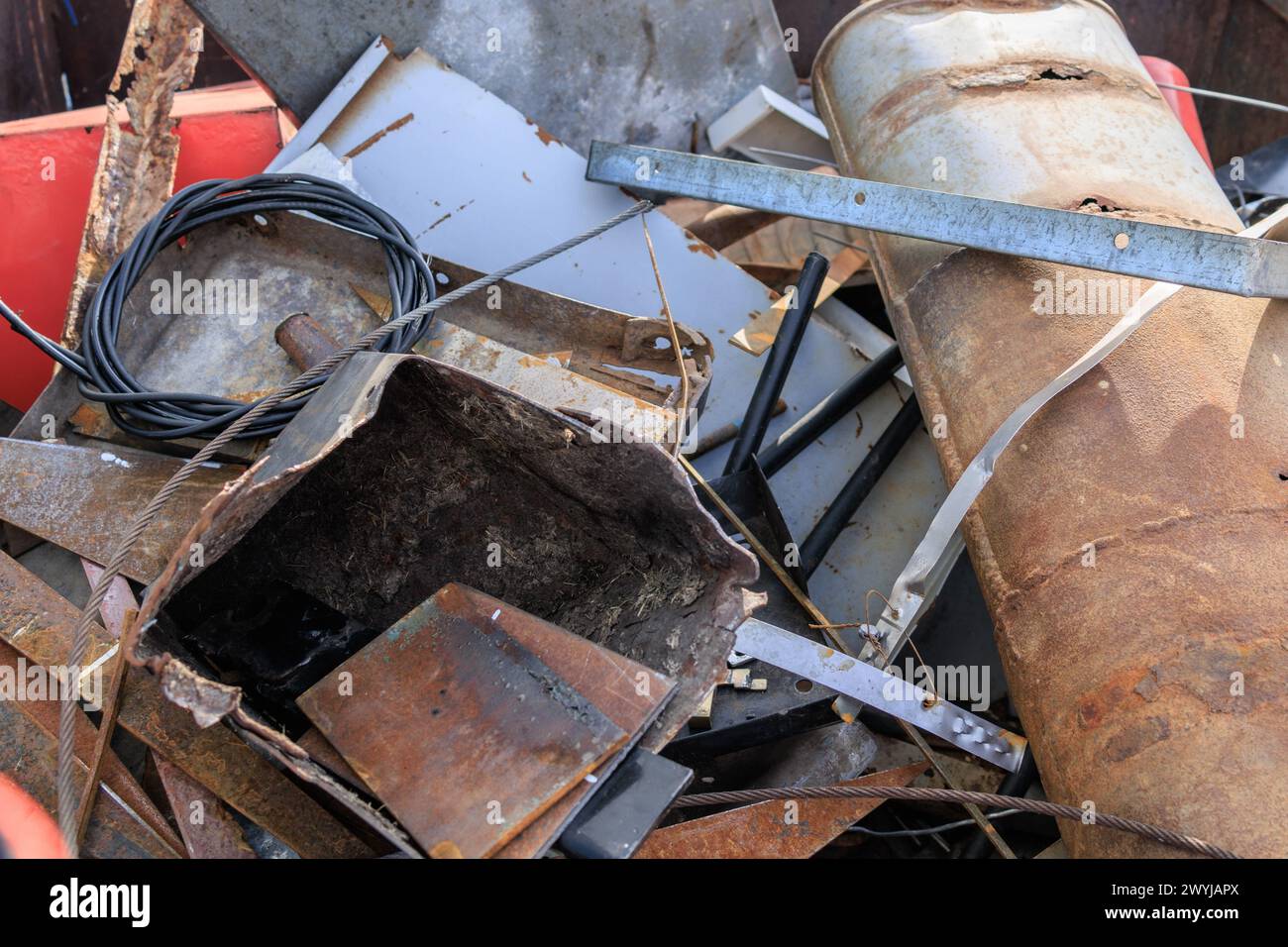 A pile of junk including a rusty pipe and a broken ruler Stock Photo ...