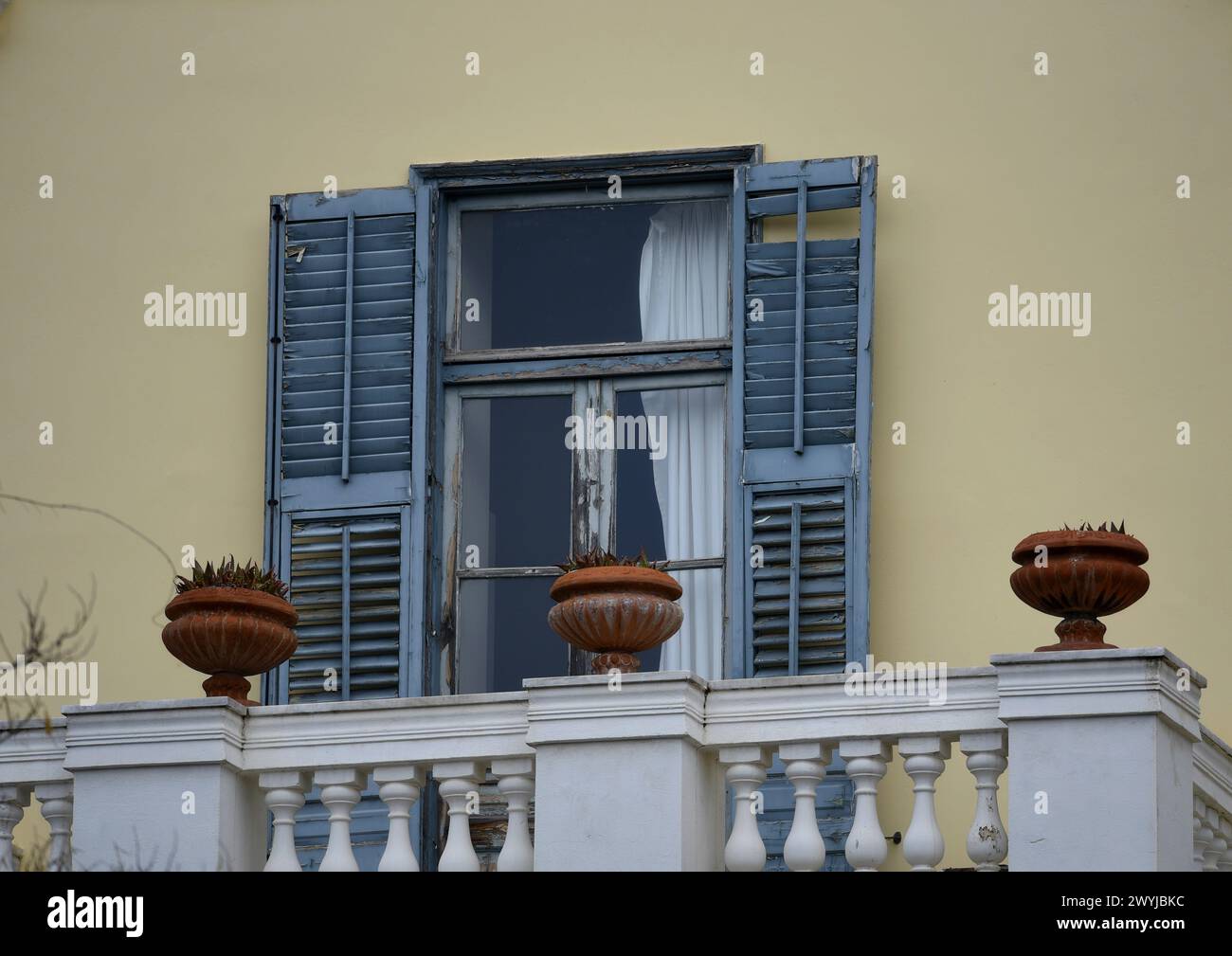 Old Neoclassical house facade with an antique wooden window and a ...