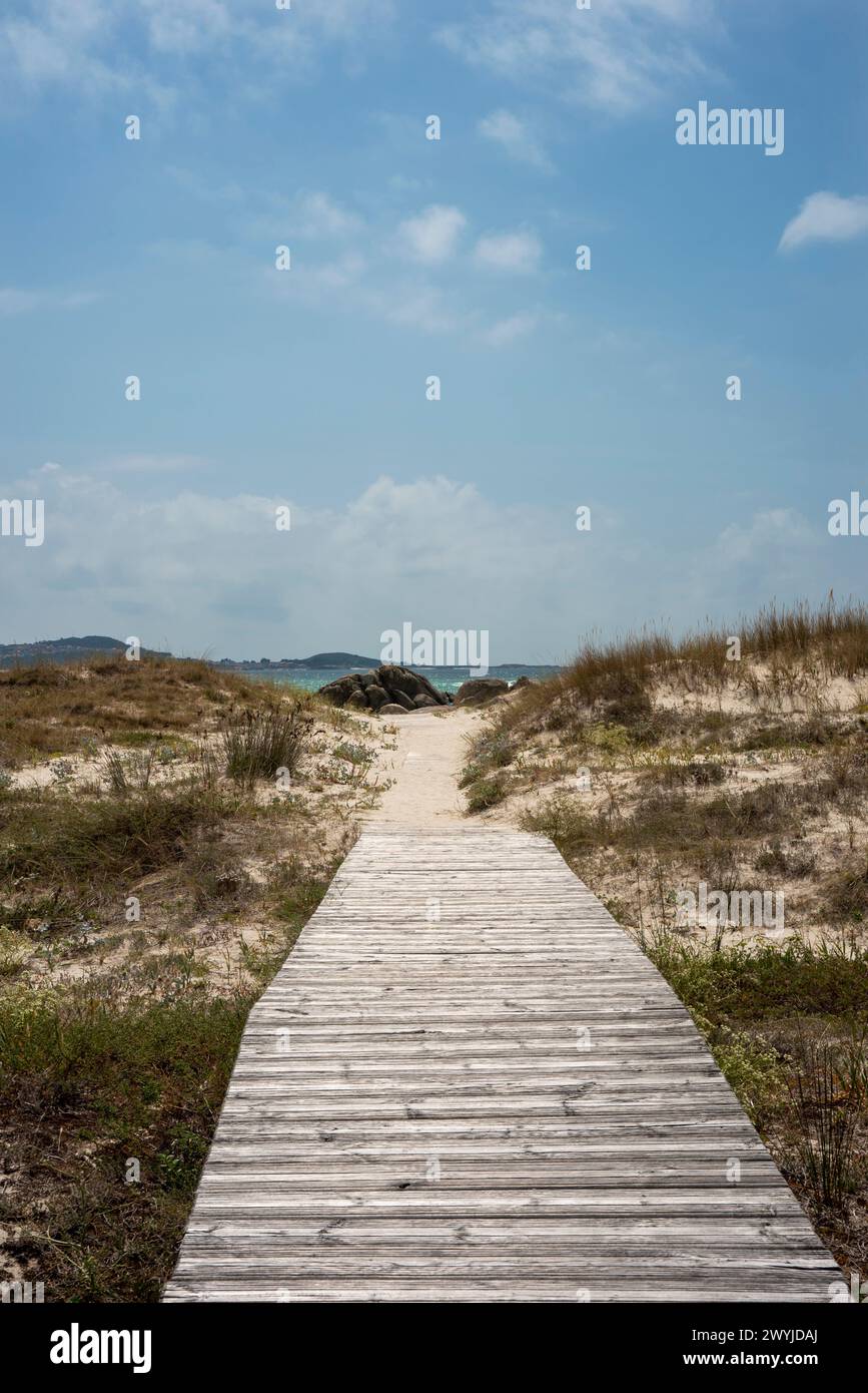 Wooden path over sand dune that gives access to the beach of Carnota ...