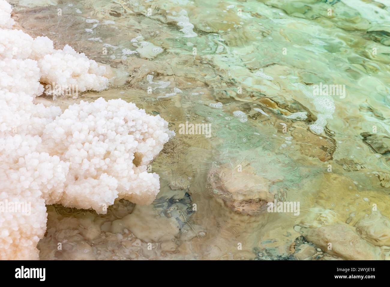 Deposits of mineral salts on the beach of the Dead Sea in Jordan ...