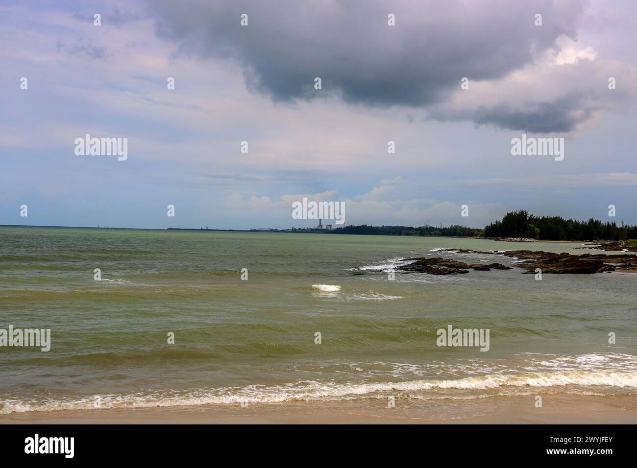 View to distant chemical processing plant over Kidurong Bay at Tanjung ...