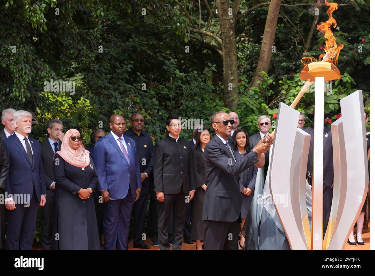 Rwandan President Paul Kagame lights a memorial flame during a ceremony ...