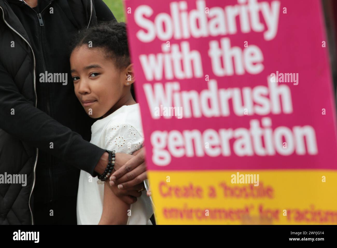 London, UK. 06th Apr, 2024. A child embraced by her mother looks on as ...