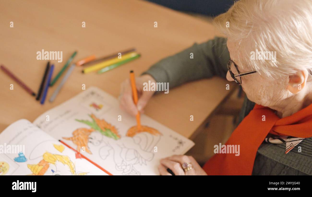 Old woman coloring a draw in a nursing home Stock Photo - Alamy