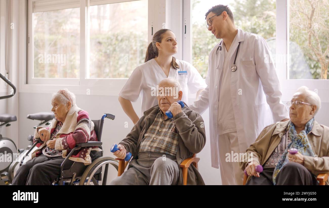 Distracted doctors talking while senior people exercising in geriatric ...