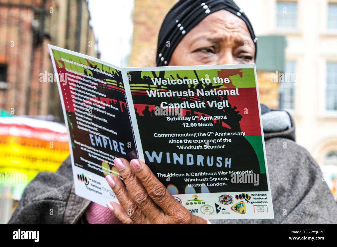 London, UK. 06th Apr, 2024. A woman reads the programe for Windrush ...