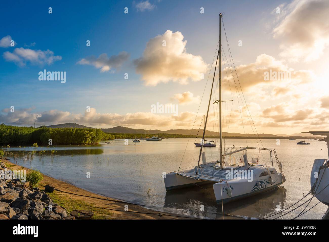 Boats moored and anchored in the late afternoon at the mouth of the ...