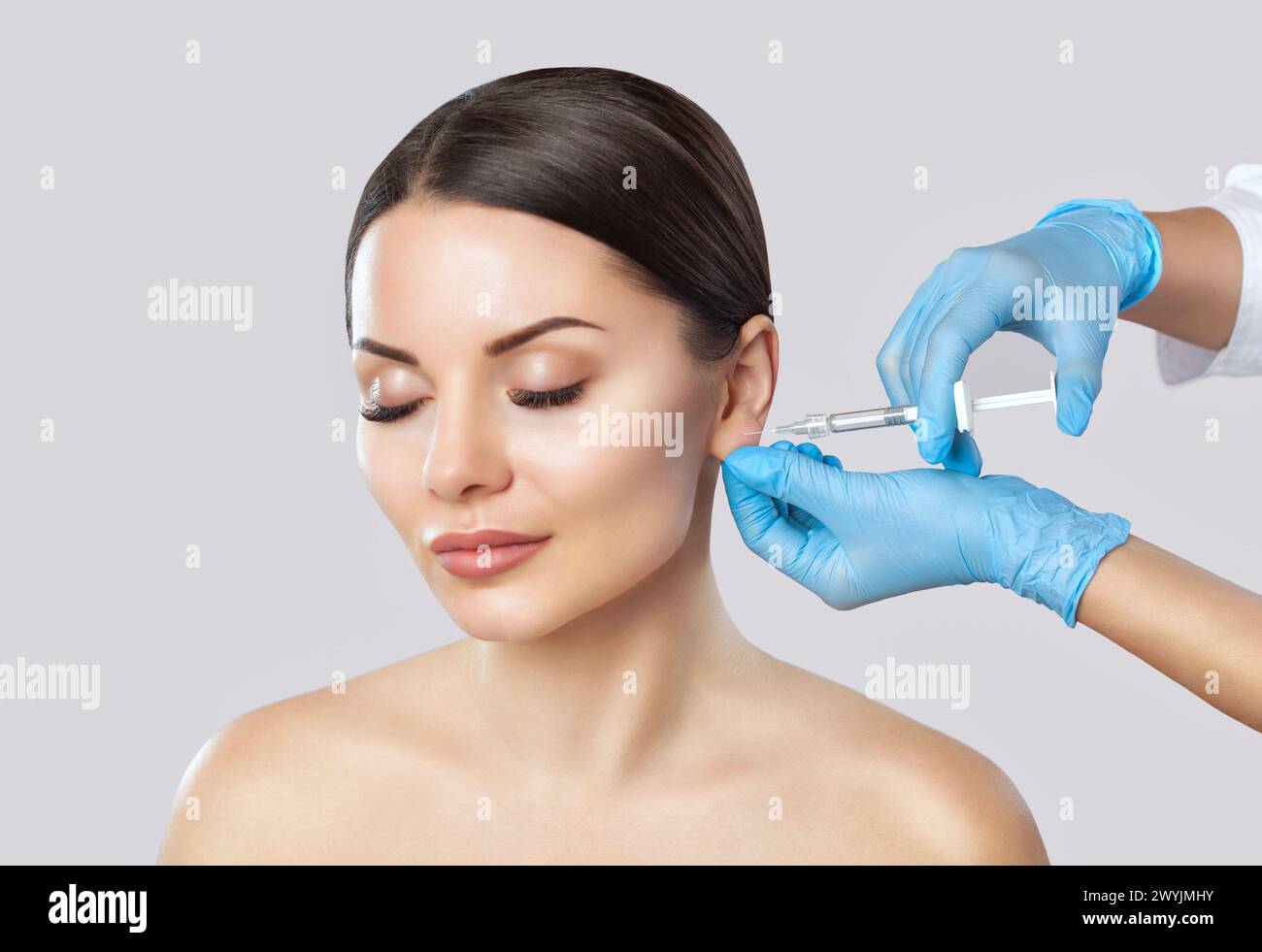 The doctor cosmetologist makes the injections procedure for smoothing ...