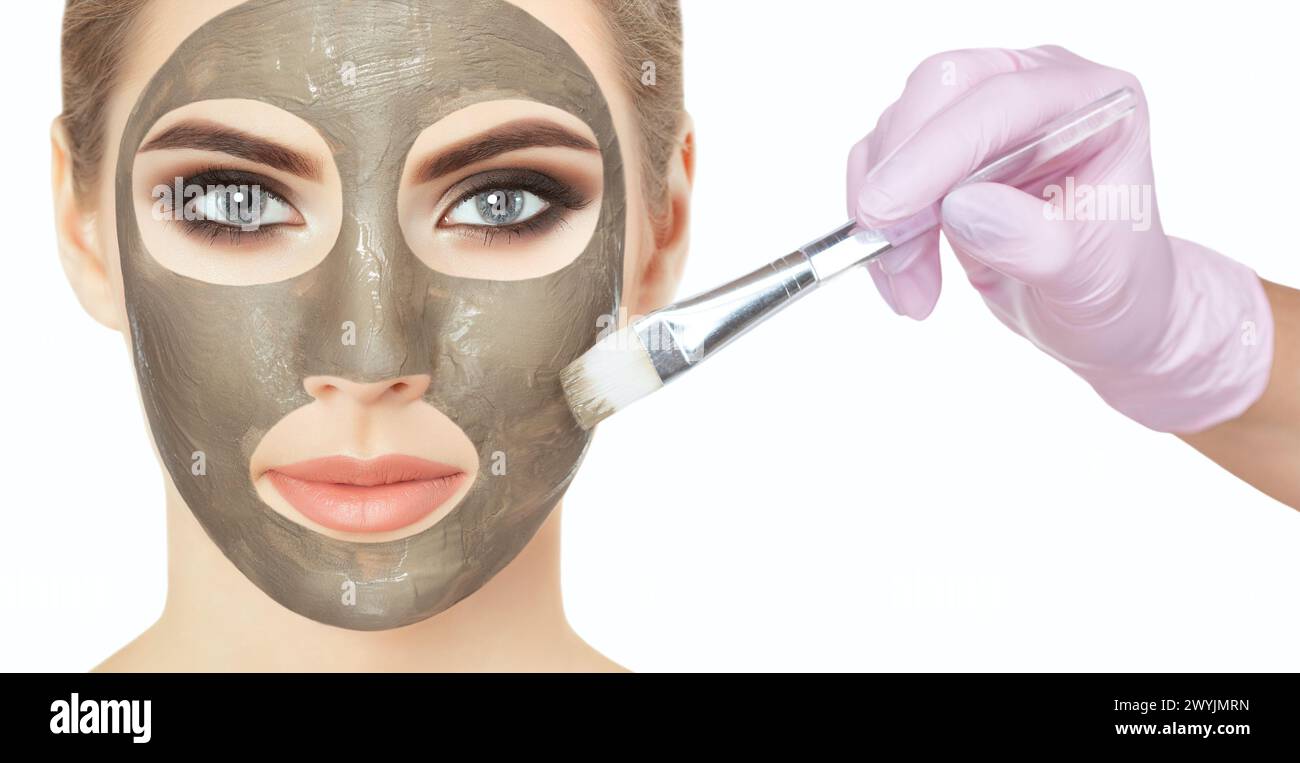 A beautiful woman makes a anti wrinkle mask on her face, she is holding ...