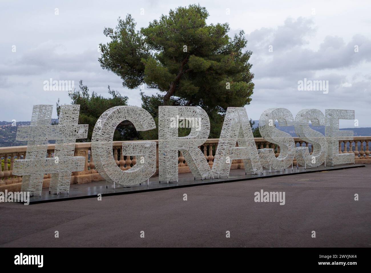 A large hashtagged sign spelling #GRASSE stands prominently at a scenic ...