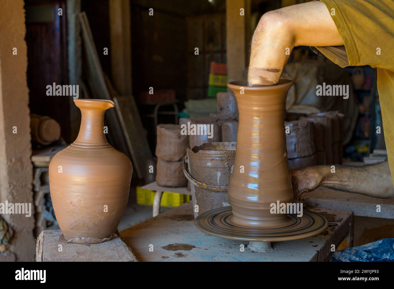 Crop person shaping clay vase on wheel in workshop Stock Photo - Alamy