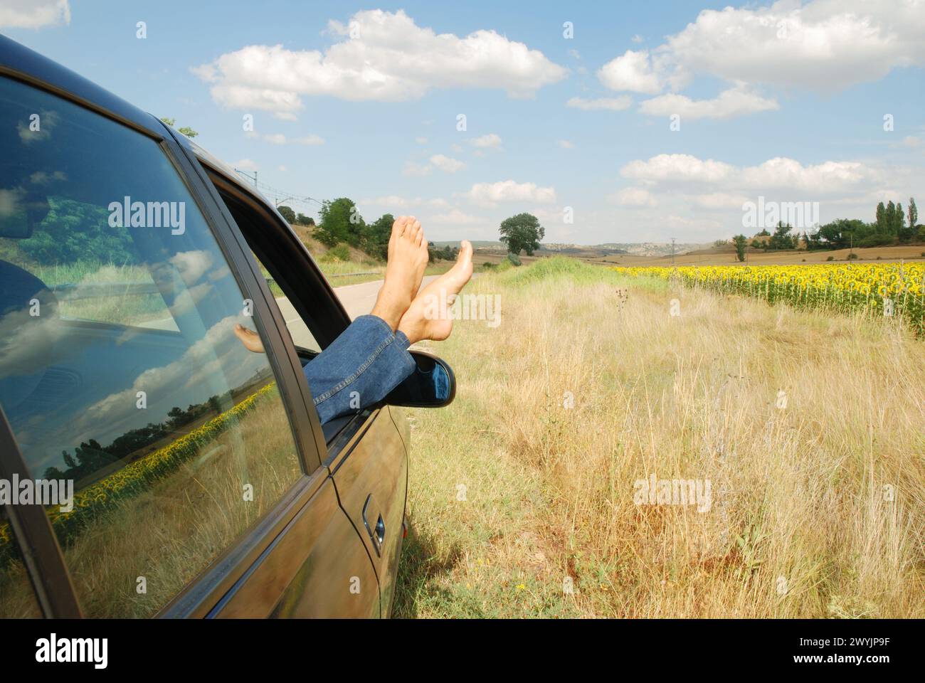 Man's feet sticking out of a car Stock Photo - Alamy