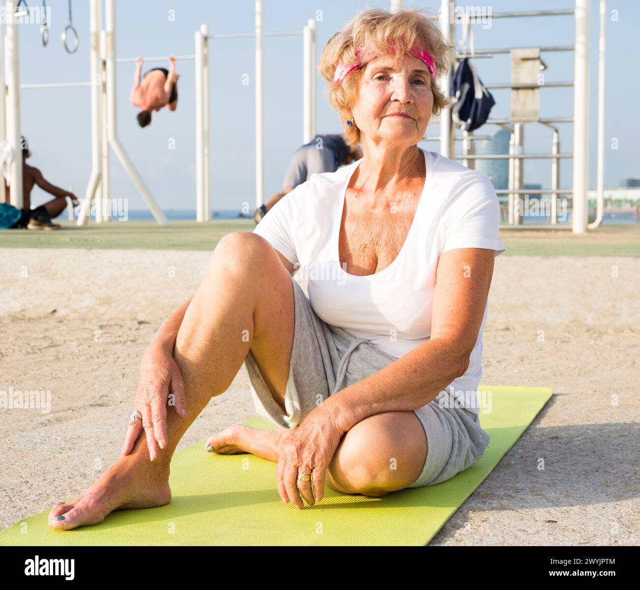 Old lady sitting on mat outdoors Stock Photo - Alamy