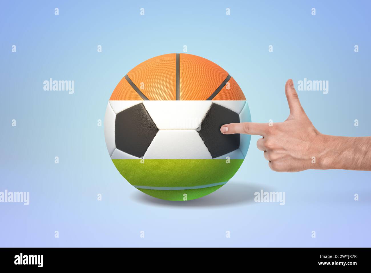 Pointing at a colorful segmented soccer ball Stock Photo - Alamy