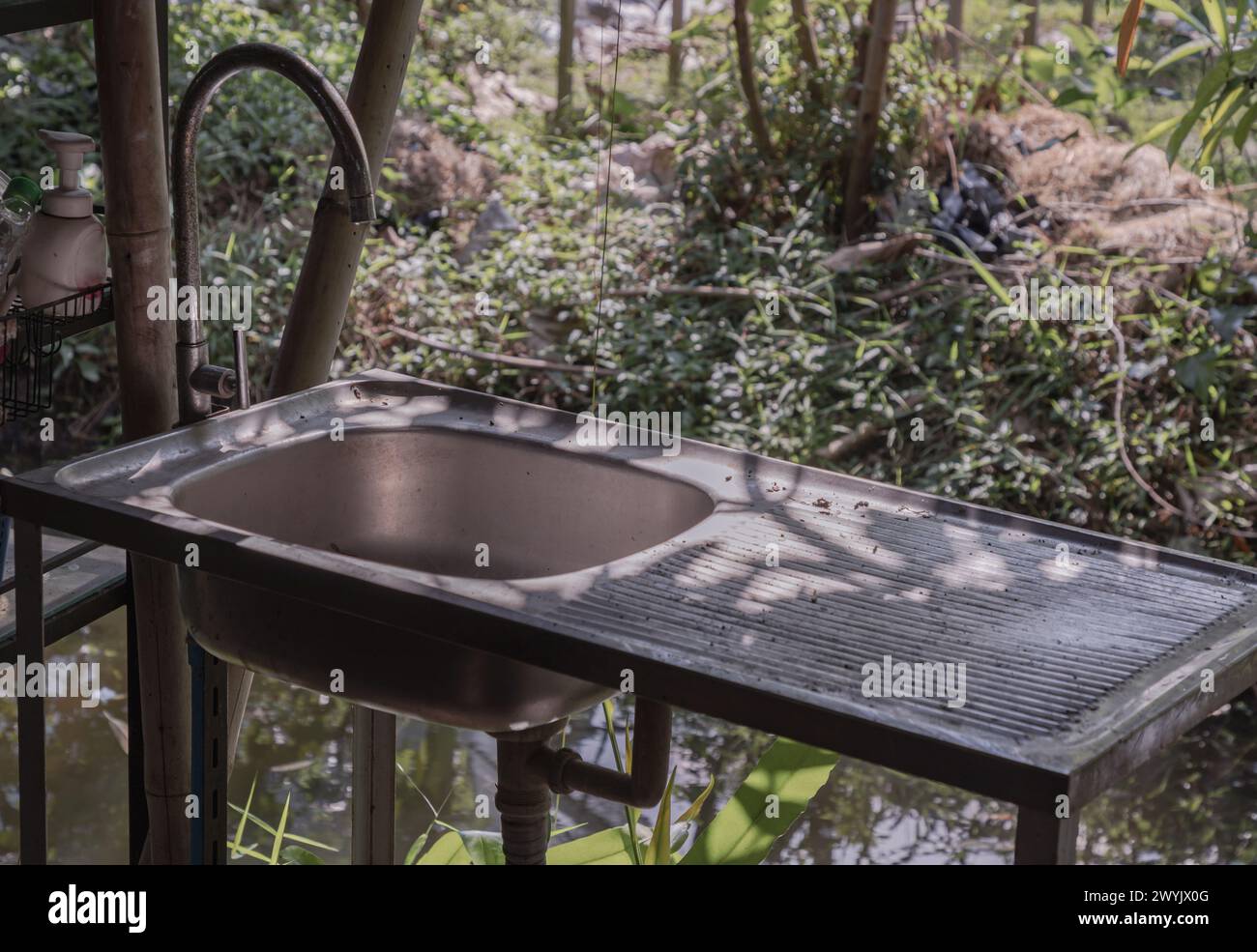 Water faucets over stainless steel sink for washing hands outside At ...