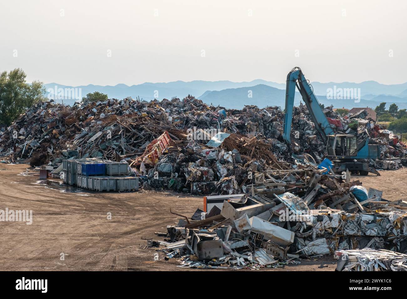 Clow crane picking up scrap metal at recycling center for metal ...