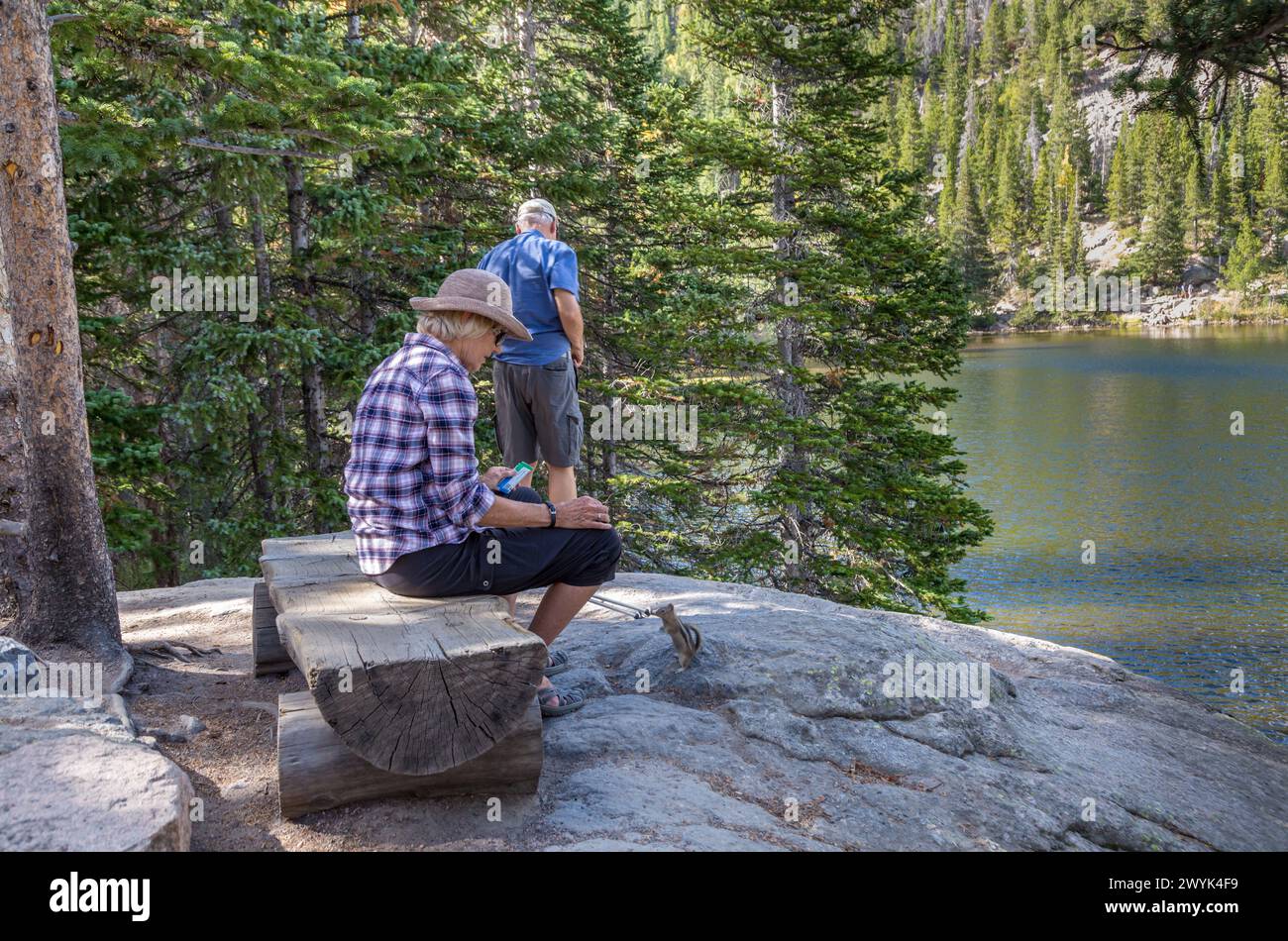 Couple sitting on bench feeding chipmonks along the Bear Lake Nature ...