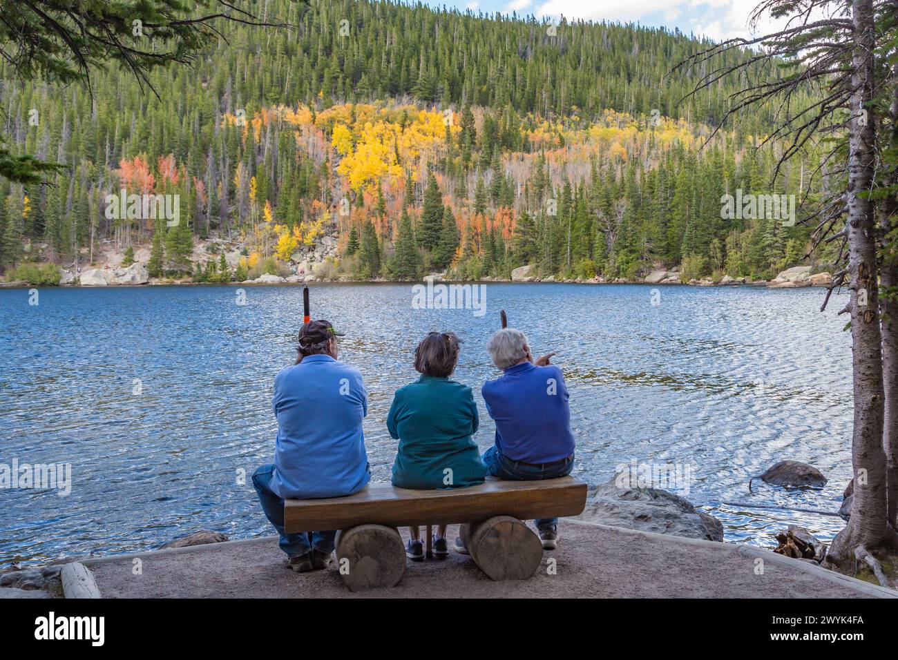 Senior Bear Lake Nature Trail hikers rest on a bench along Bear Lake in ...