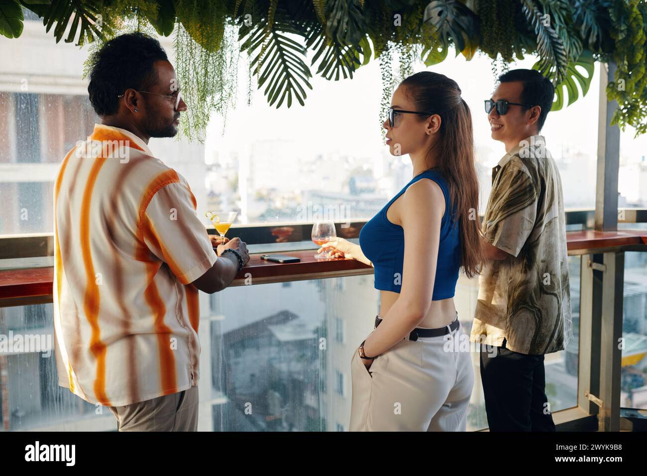 Colleagues spending time in rooftop bar after work Stock Photo - Alamy