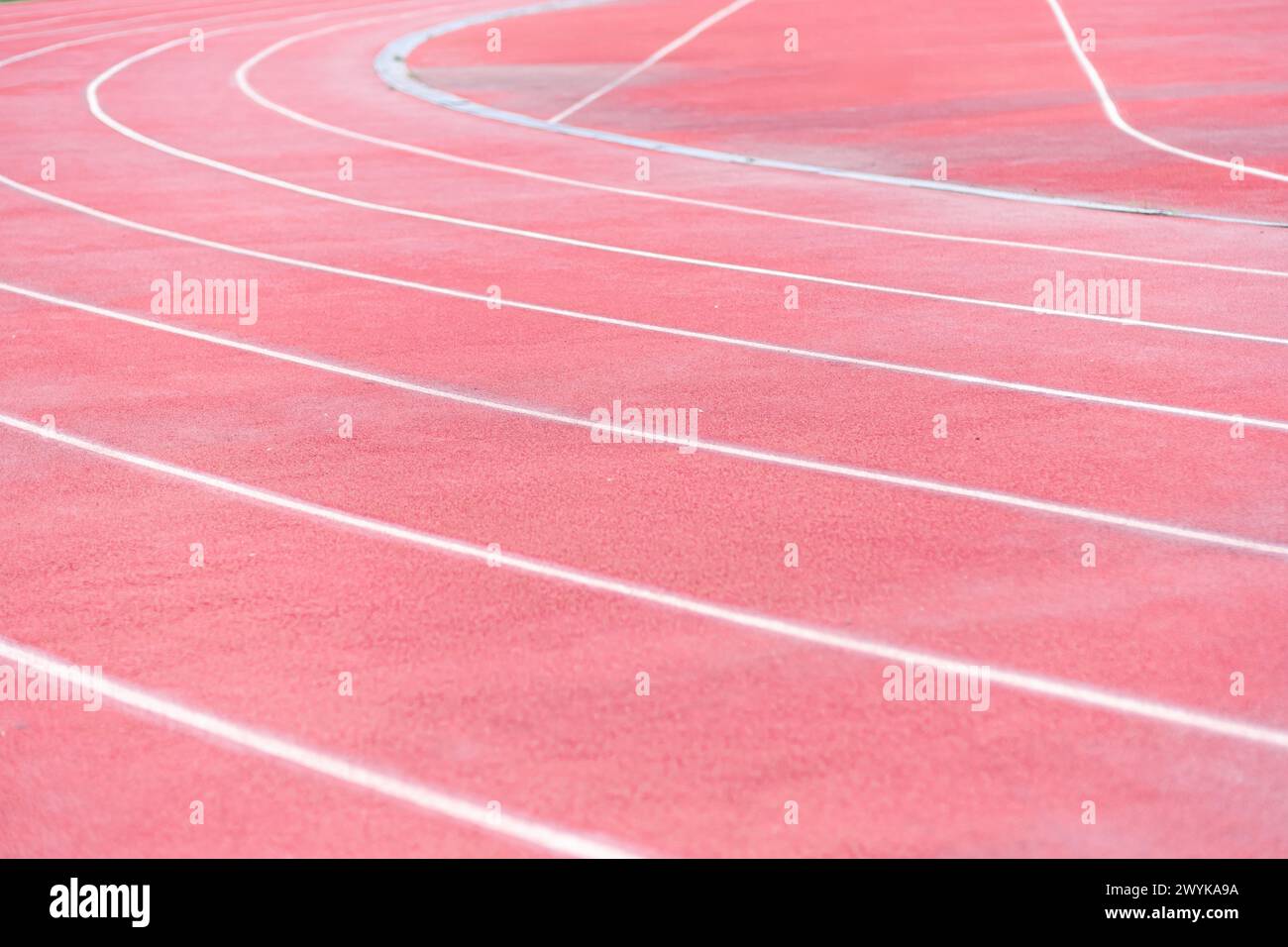 red rubberized running track, fueling their exercise at sports ground ...