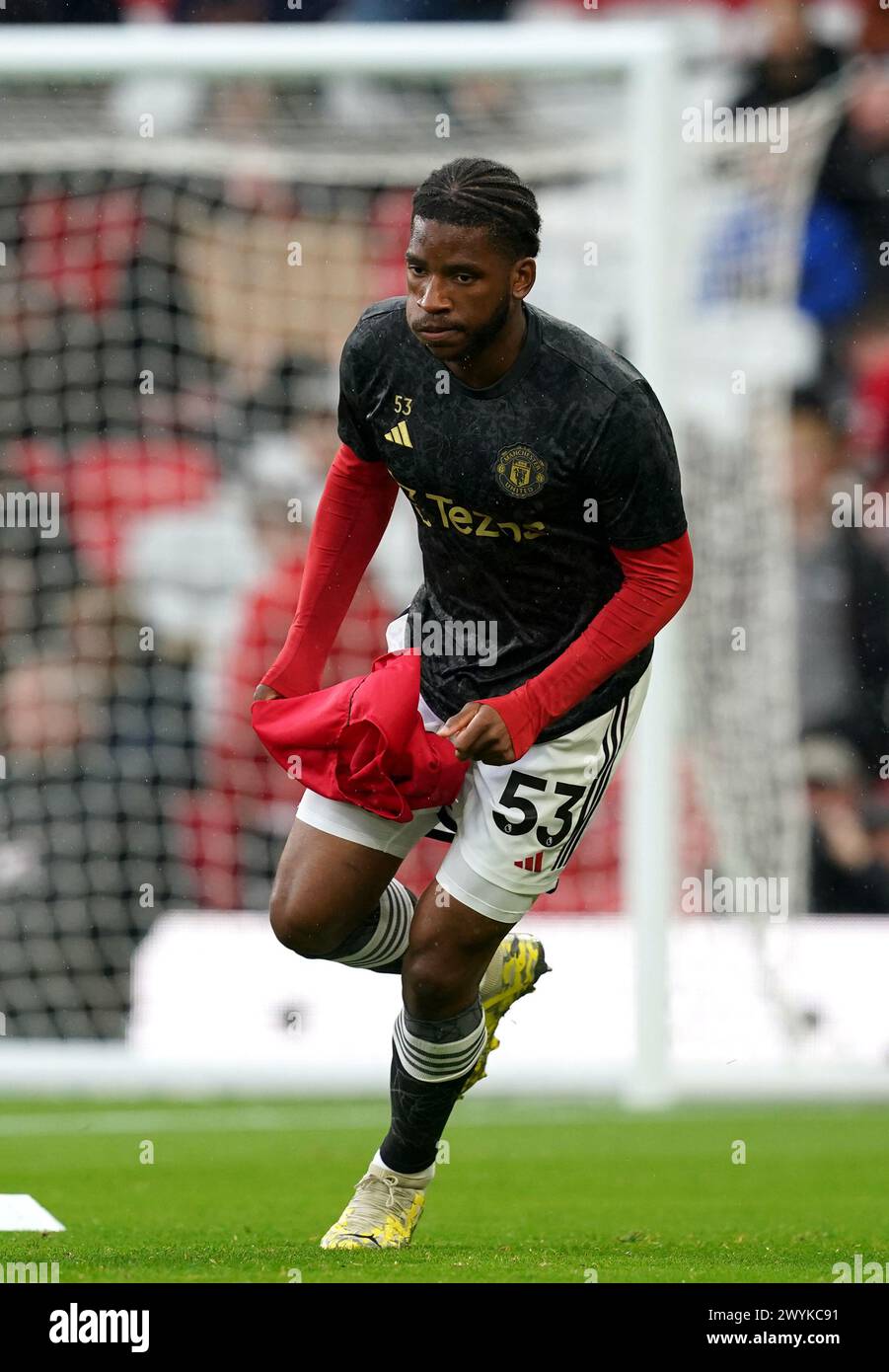 Manchester United's Willy Kambwala warming up before the Premier League ...