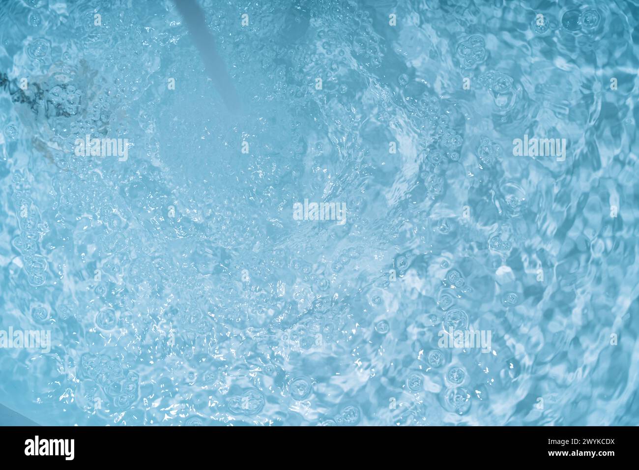 Stream of water flows from a faucet into a swimming pool Stock Photo ...