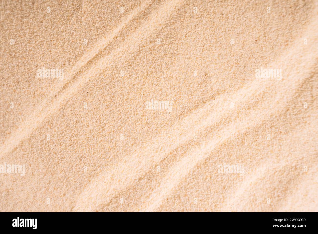 Yellow clean sand with wavy patterns Stock Photo - Alamy