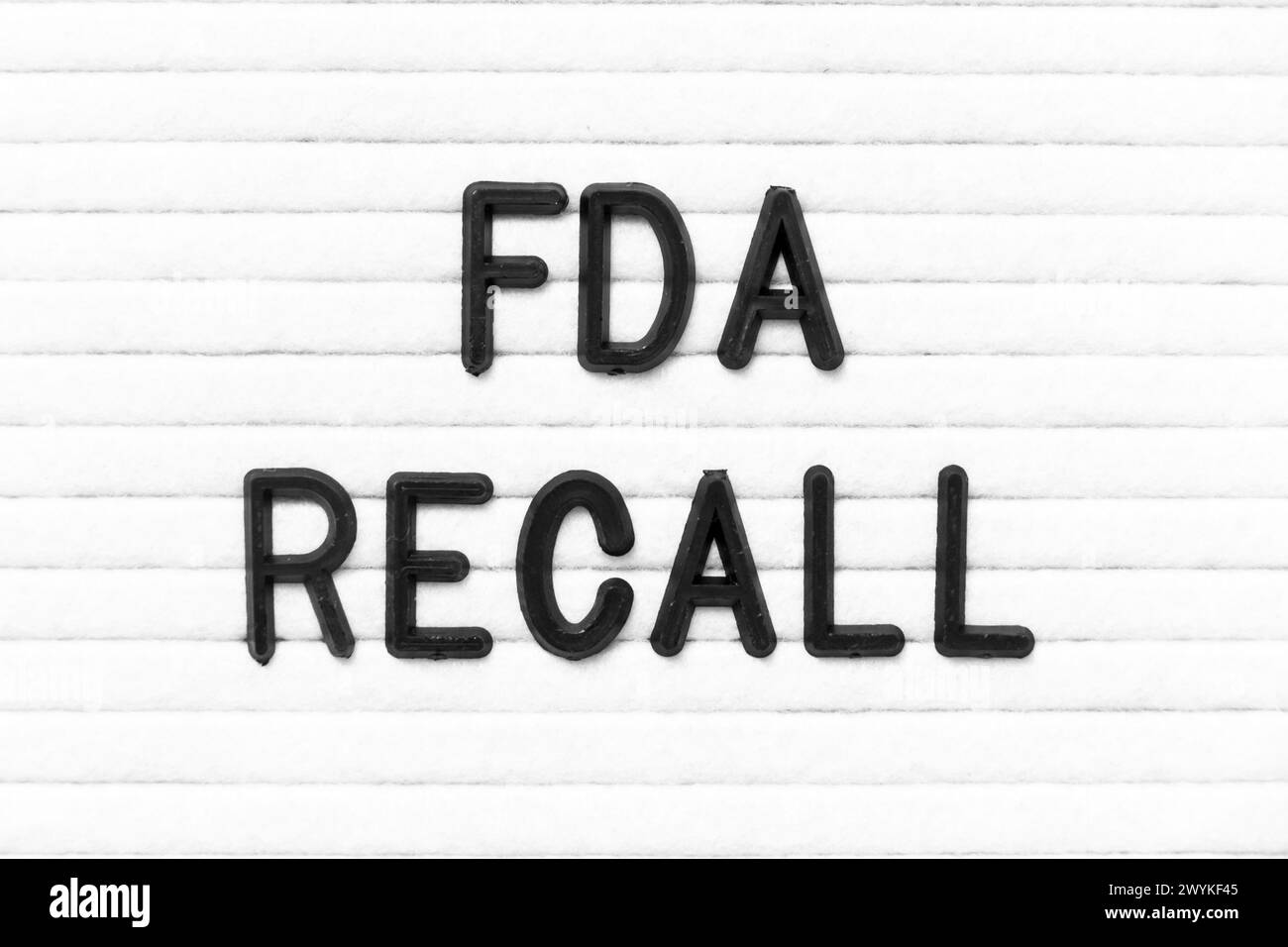 Black color letter in word FDA recall on white felt board background ...