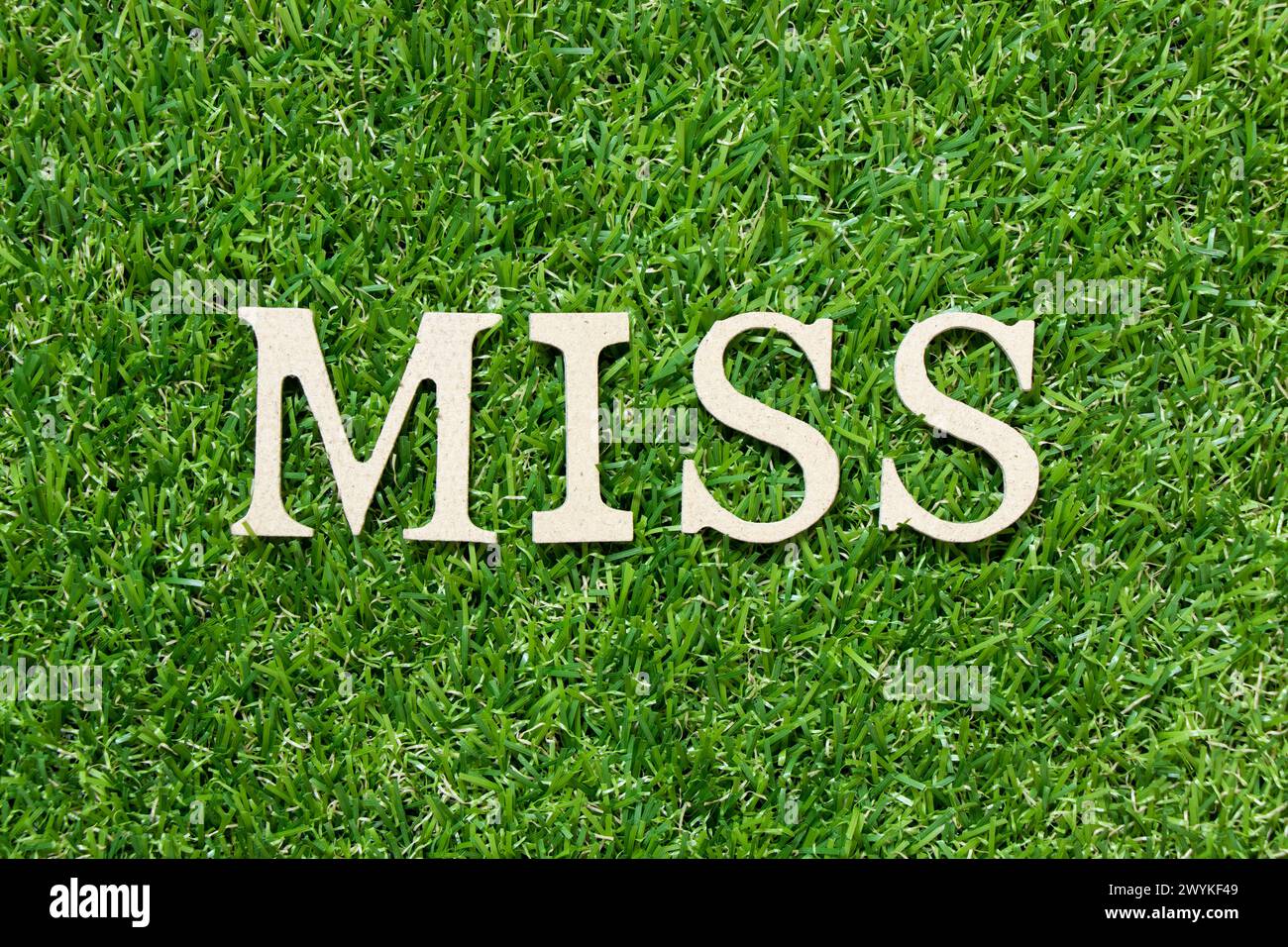 Wood letter in word miss on green grass background Stock Photo - Alamy