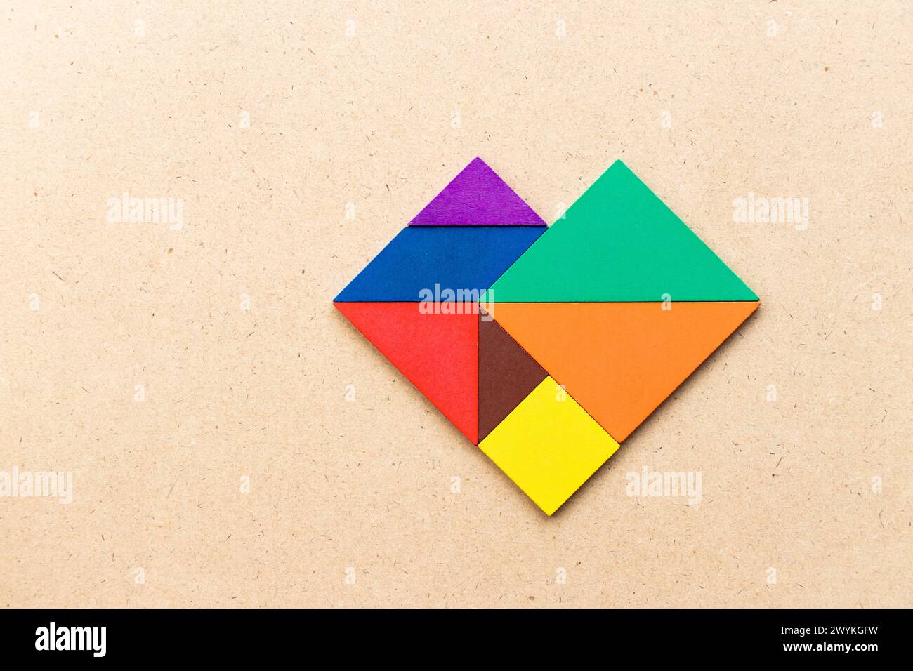 Color tangram puzzle in heart shape on wood table Stock Photo - Alamy