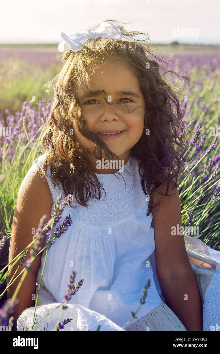 Beautiful girl in a field of lavender on sunset. family vacation ...