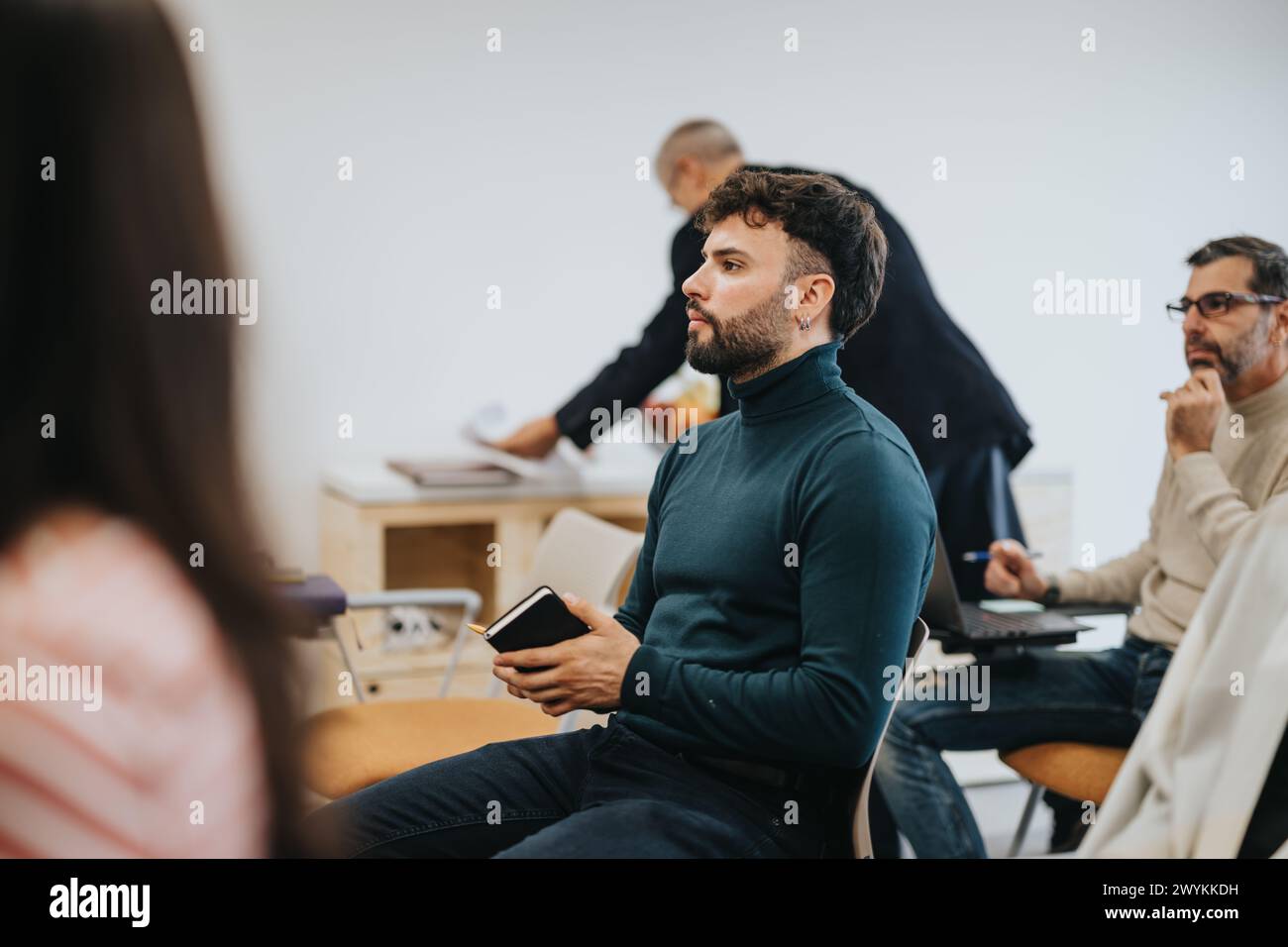 Engaged adults partake in a business meeting in a casual setting ...
