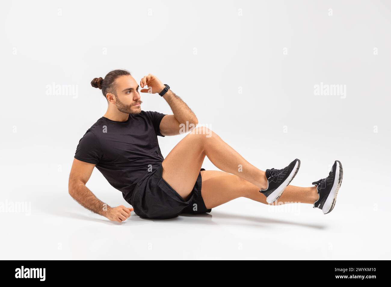 Man doing sit-ups exercise on studio background Stock Photo - Alamy