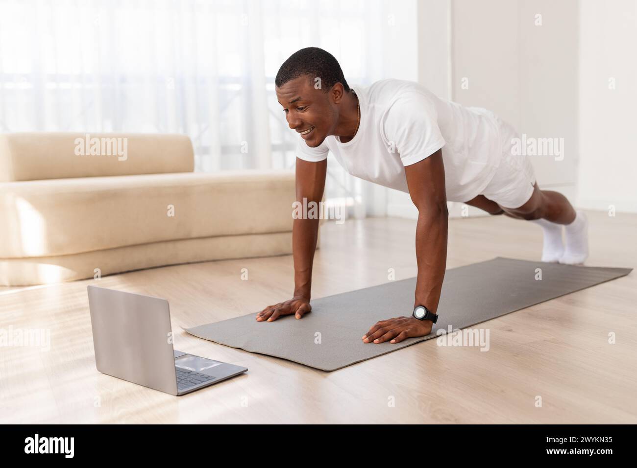Man in a push-up position in a clean room Stock Photo - Alamy