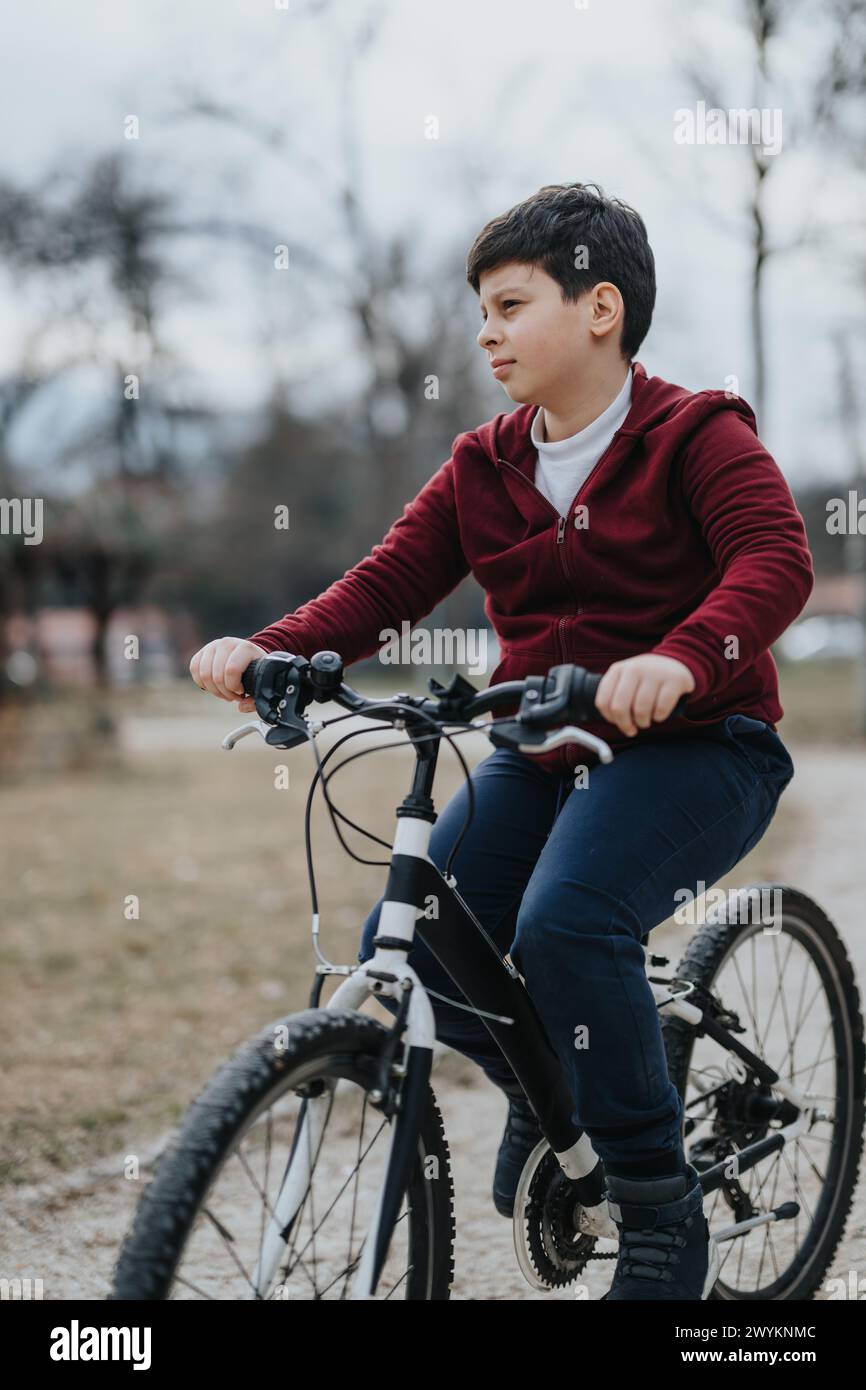 Young boy enjoying a bike ride in the park, capturing the essence of ...
