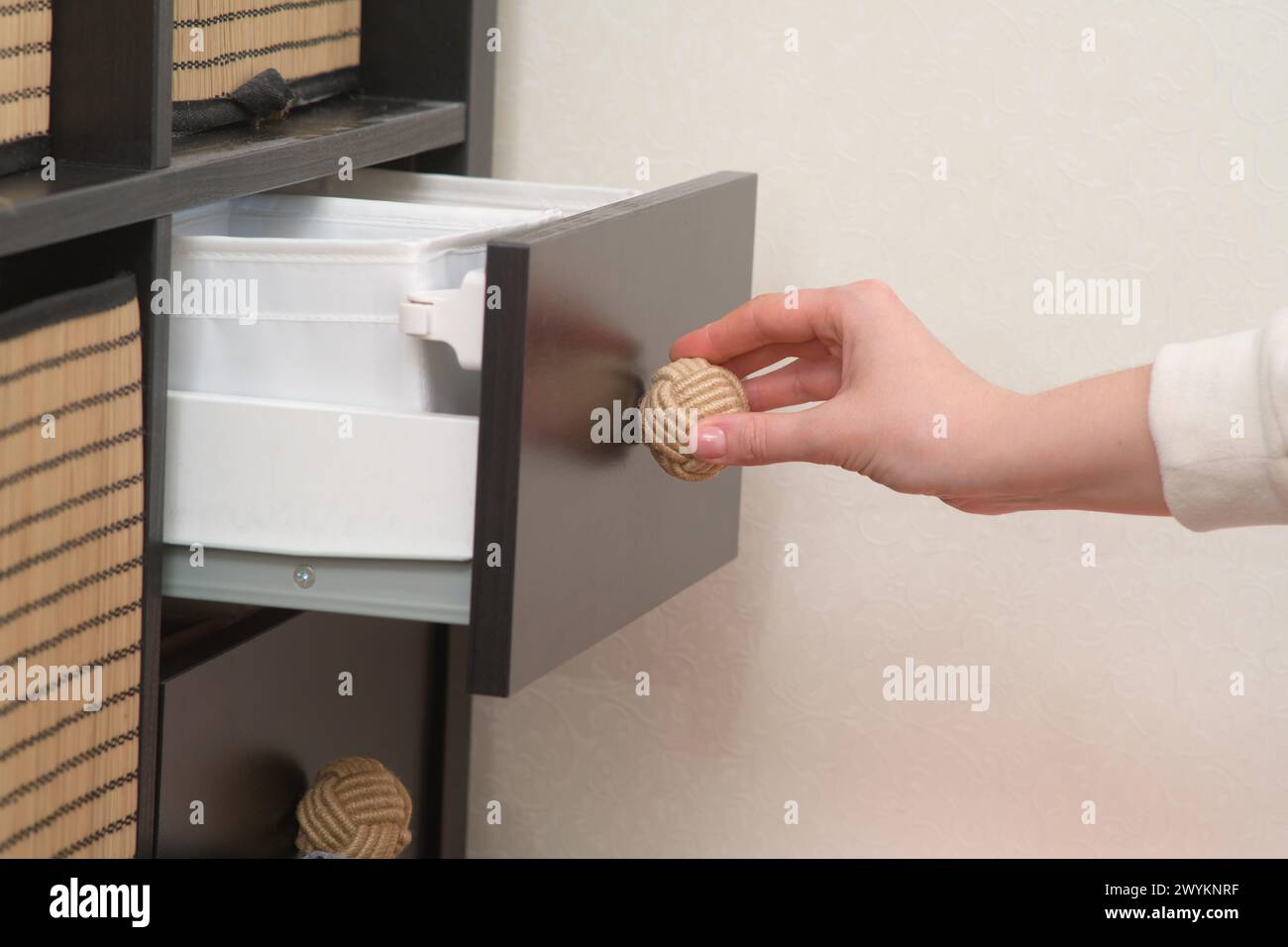 A woman's hand opens a drawer, close-up. Cabinet drawer Stock Photo - Alamy