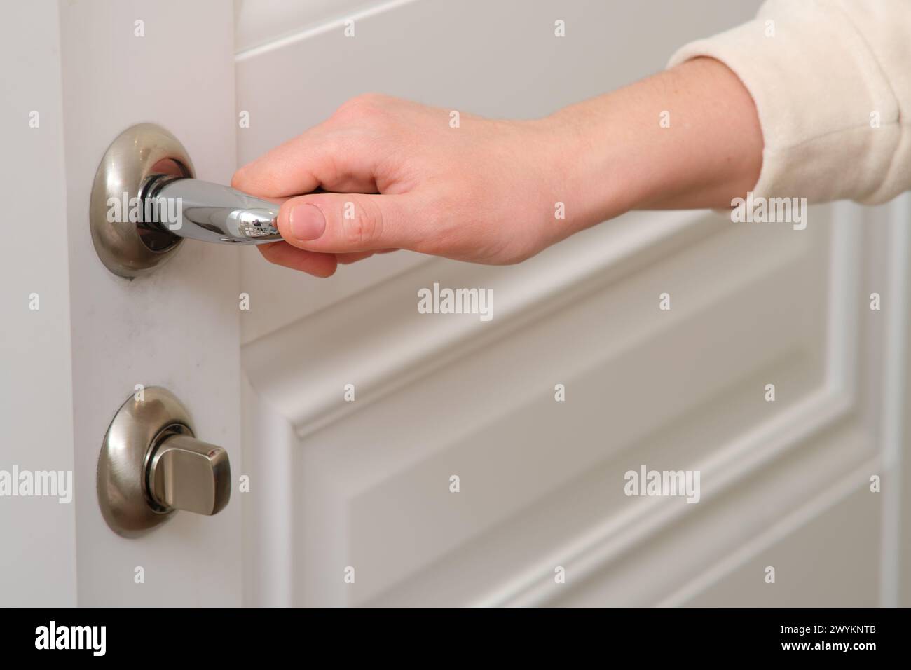 Hand touching metal door hi-res stock photography and images - Alamy