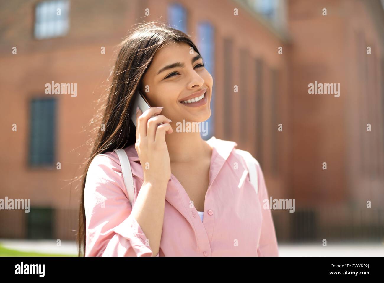 Happy student talking on the phone outdoors Stock Photo - Alamy