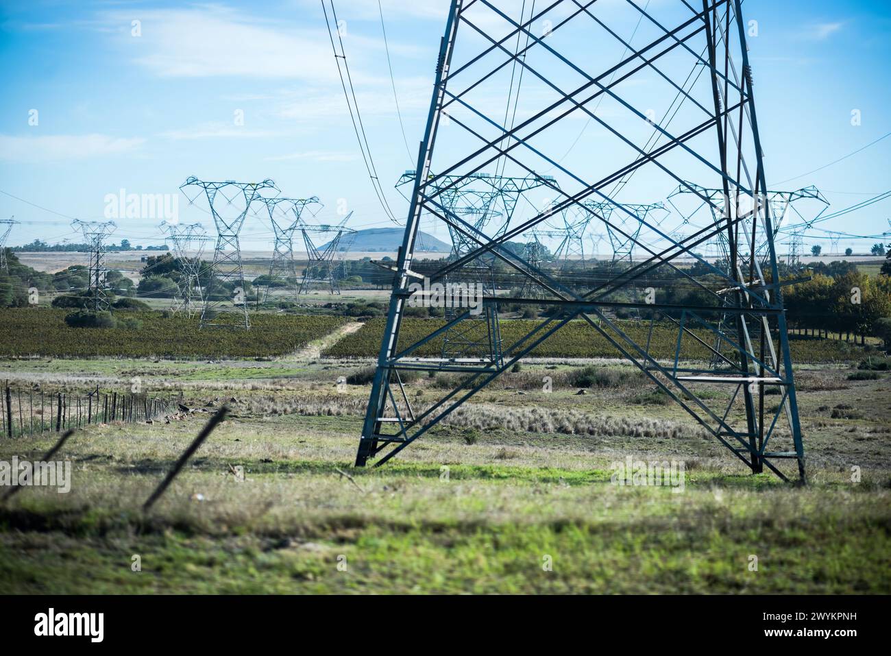 A network of high voltage power lines stretches across a rural ...