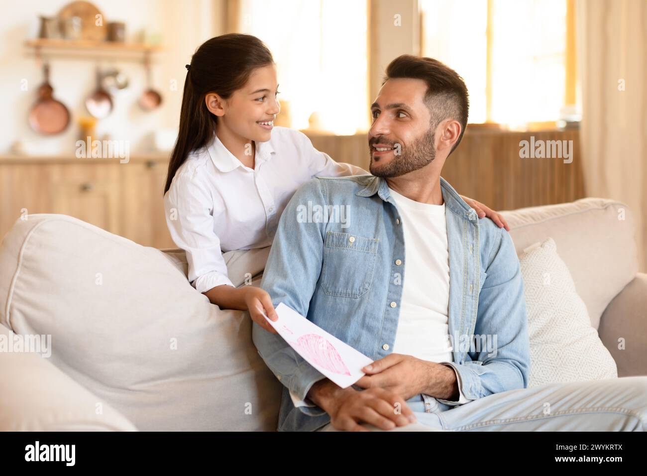 Father and daughter reading a card together Stock Photo - Alamy