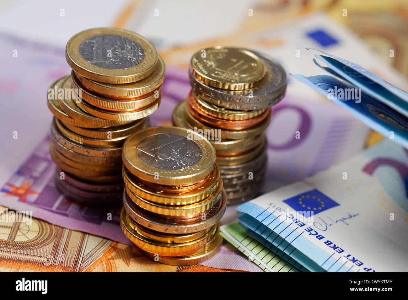 Stacked euro coins and banknotes close up photo with narrow depth of ...