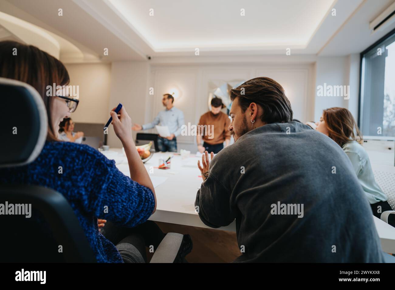 Collaborative coworkers engaging in a productive team meeting at modern ...