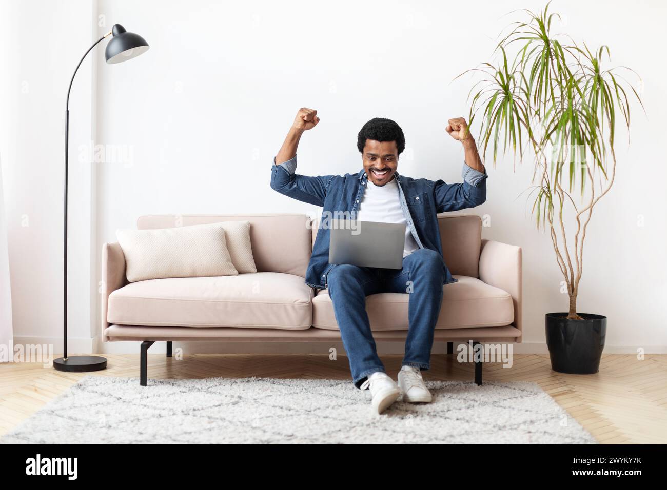 Joyful Black Man Celebrating Success At Home With Laptop Stock Photo ...