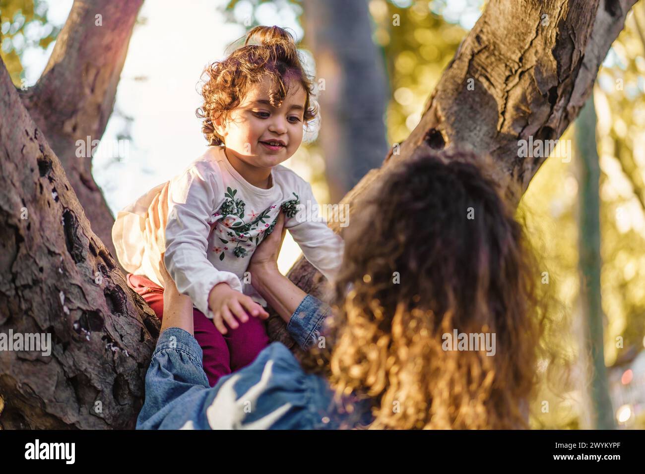 In the heart of the park, a mom's care shines through as she supports ...