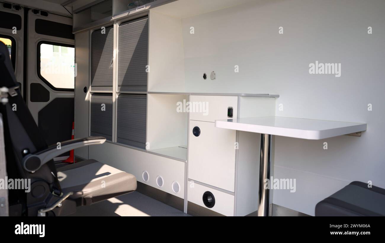 Panoramic view of an organized, clean ambulance interior with medical ...
