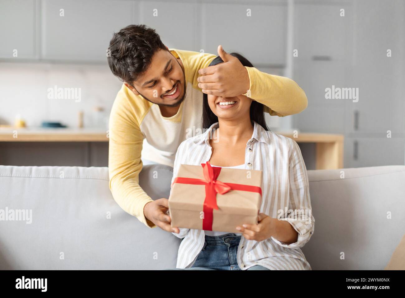 Indian man giving gift woman hi-res stock photography and images - Alamy