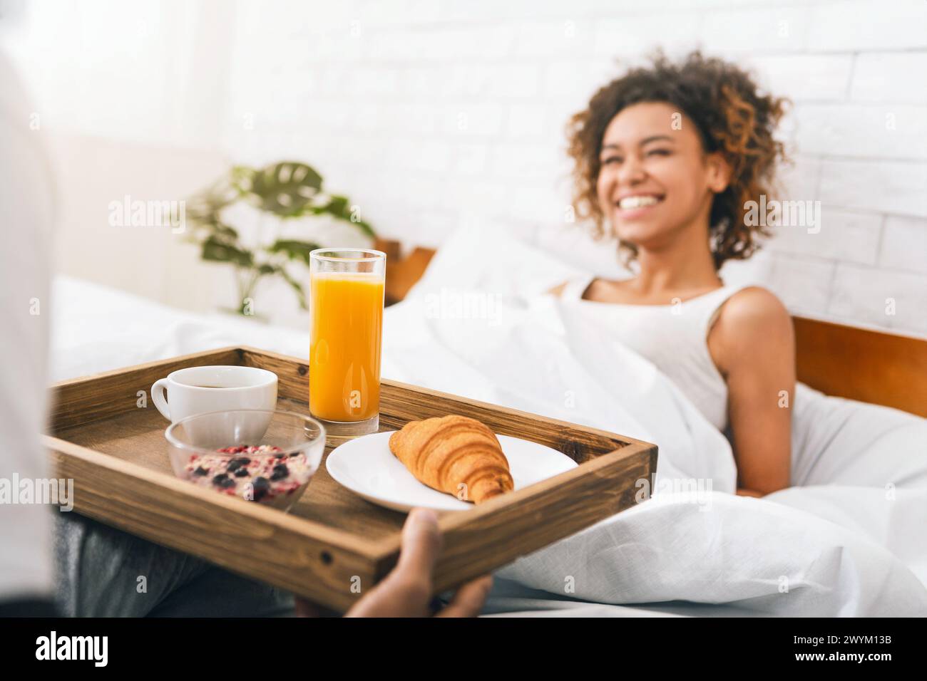 Boyfriend bring some breakfast to his girlfriend in bed Stock Photo - Alamy