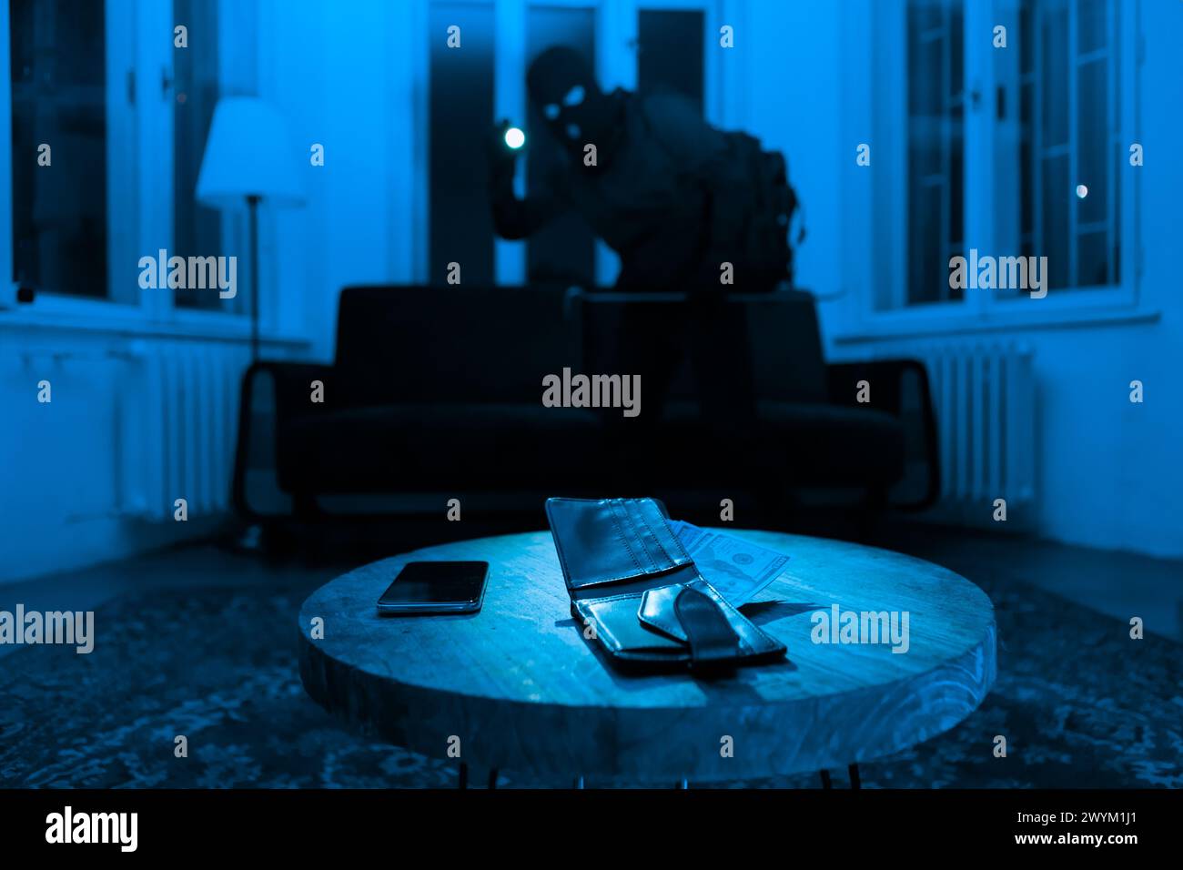 Thief stealing valuables from house at night Stock Photo - Alamy