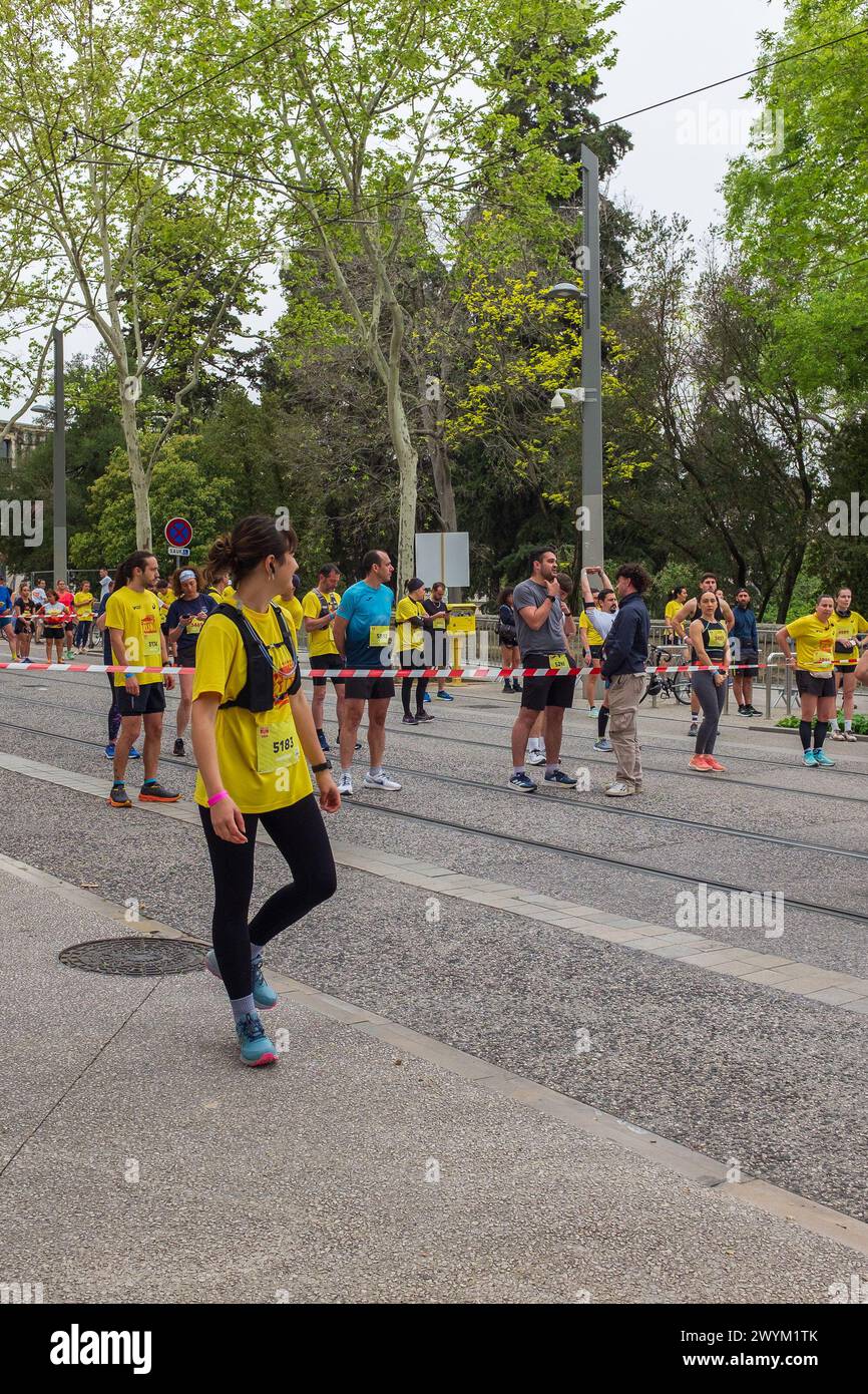 Montpellier, France. 7th Apr 2024. Runners warming up in front of the ...