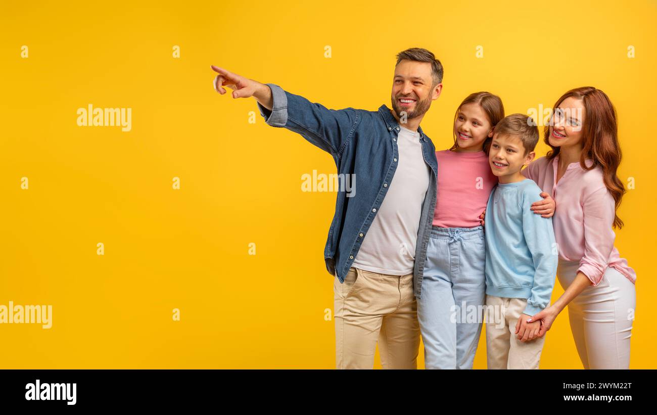 Father pointing and leading family on yellow Stock Photo - Alamy